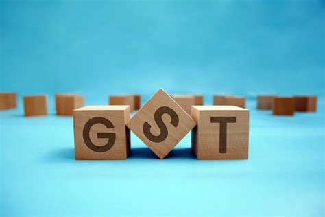 Premium Photo Gst On Wooden Surface On Beautiful Blue Background With Copy Space Business