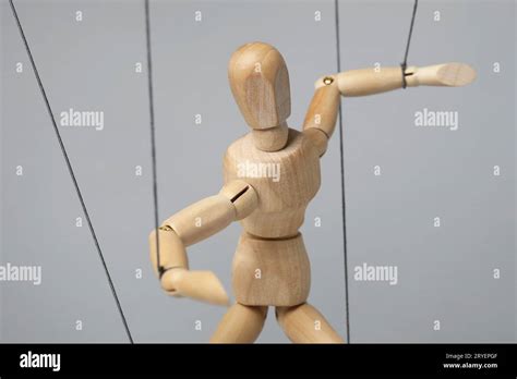 One Wooden Puppet With Strings On Light Grey Background Stock Photo Alamy