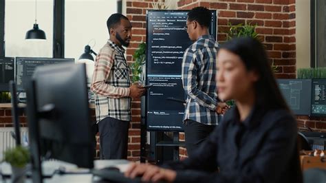 Premium Photo Programmers Leaving After Analyzing Source Code On Wall