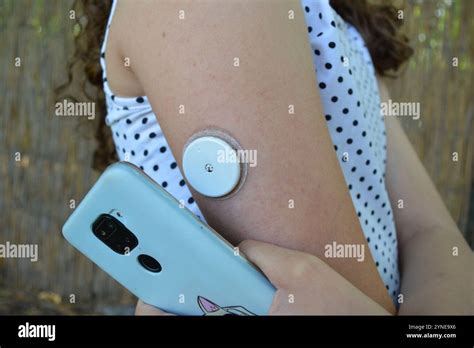 Girl Use Application On Mobile Phone To Read Sensor For Continuous