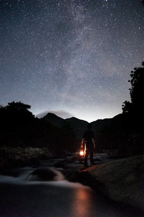 강 검은 하늘 경치가 좋은 고독 고요한 고요함 광야 그림자 긴 노출 남자 등불 락 랜턴 레저 먼 산들