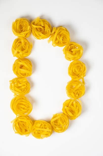 Premium Photo Few Homemade Fettuccine Nest In The Shape Of The Letter