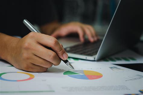 Businessman Holding Pen Document Graph Accounting Finance Paper Work Analysis Chart Marketing