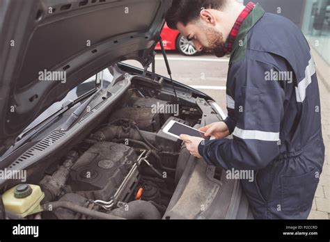 Handsome auto mechanic using hi-res stock photography and images - Alamy