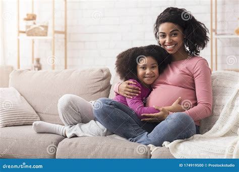 Happy Expecting Afro Woman Hugging with Her Little Daughter at Home Stock Photo - Image of ...