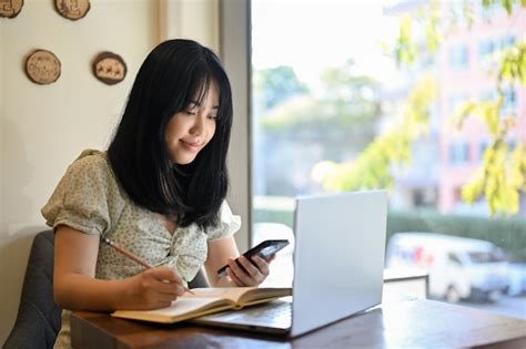 Premium Photo Pretty Asian Female College Student Doing Her Homework