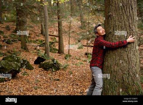 Man Hugging Tree Smiling Stock Photo Alamy