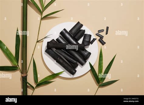 Activated Bamboo Charcoal Placed On A White Podium In Round Shaped