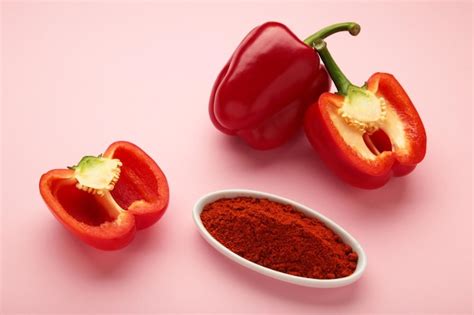 Premium Photo Paprika Powder In Plate With Fresh Red Pepper On Pink