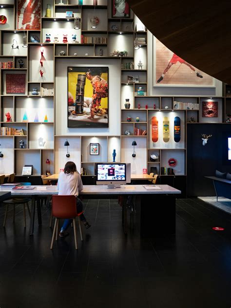 흰색 긴 소매 셔츠를 입은 여자가 컴퓨터 앞에 의자에 앉아 있다 사진 Unsplash의 무료 미국 이미지