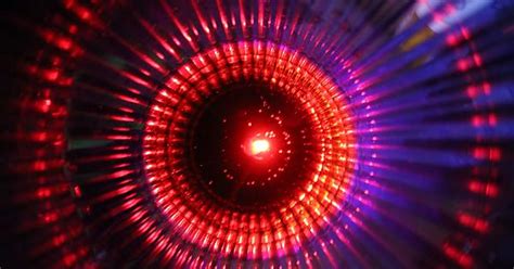 Shining A Flashlight Through The Clear Purple Plastic Cup Filled A Third Of The Way With Cola