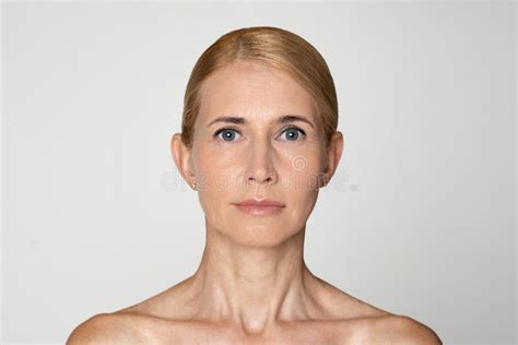 Mature Woman With Blonde Hair And Blue Eyes Against White Stock Image