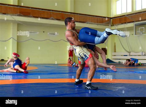 Man Wrestler Throwing The Opponent On A Wrestling Mat Training