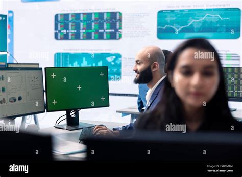 Enterprise Worker Examining Annual Sales Statistics Next To Green