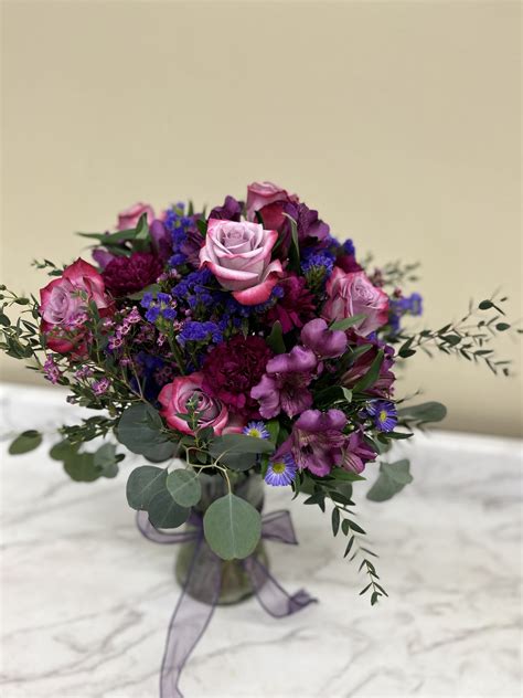Purple Status Wax Alstroemeria Roses Aster And Other Greenery In
