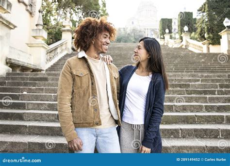 Lovely Multiracial Couple Staring At Each Other In A Park Two Happy