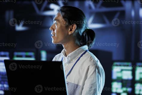 Cheerful Bipoc Man Between Server Hub Rows Providing Processing