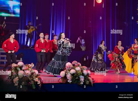 A Team Of Musicians And Singers Perform On Stage In Front Of The