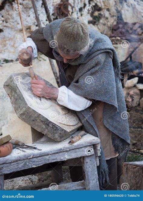 Stonemason Carves And Shapes The Stone With A Wooden Hammer And Chisel