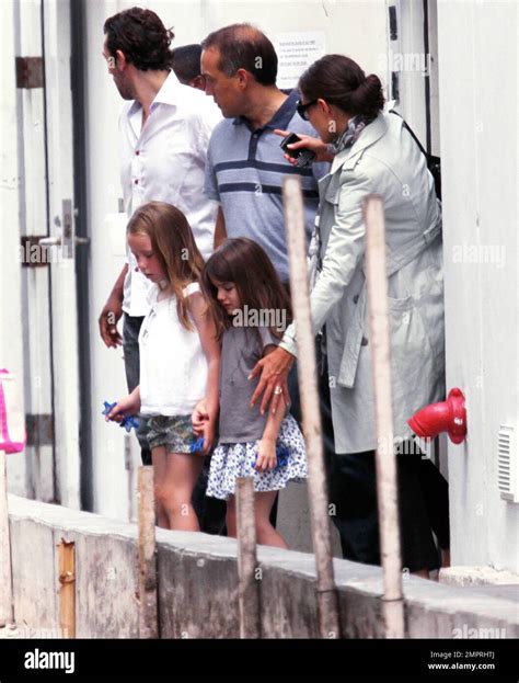 Katie Holmes Helps Daughter Suri And Her Friend Over A Wall As They
