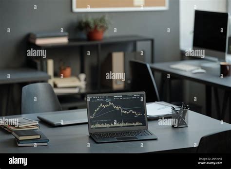 Workplace Of Stock Market Analyst With Graphic Data Illustrating