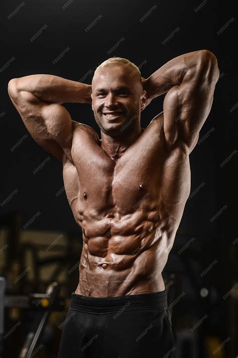 Premium Photo Handsome Strong Athletic Men Pumping Up Muscles Workout