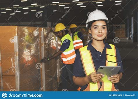 Portrait Indian Female Foreman With Laptop Checking Stock In Warehouse