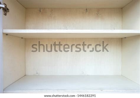 Empty Shelves In White Wooden Cupboard
