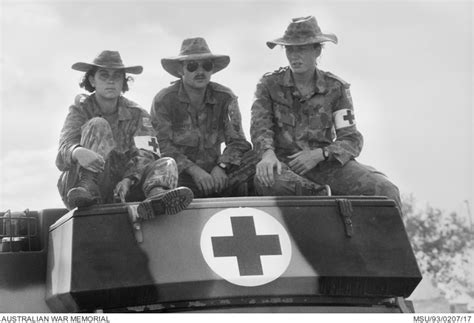 Australian Medics Sitting On Top Of A Medical Vehicle While Watching
