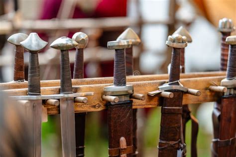 A Row Of Swords Are Displayed On A Wooden Rack Stock Image Image Of