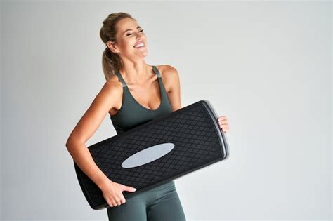 Premium Photo Adult Woman Holding Stepper Over Bright Background