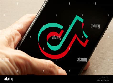 TikTok Application Icon On Apple IPhone Screen Close Up Hand Holding Smartphone With Tik Tok