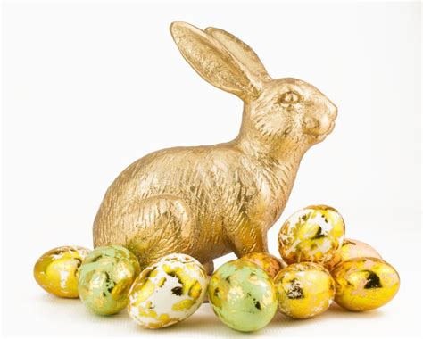 Gold Bunny Rabbit On White Background With Gold Eggs Stock Image