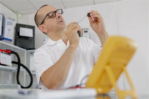 Electrician Checking Socket Voltage Using Multimeter Stock Image
