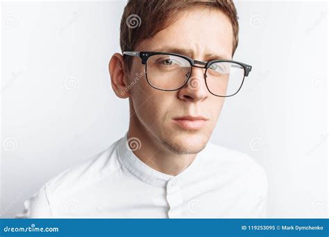 Portrait Of Young Attractive Guy In Glasses In White Shirt Isolated