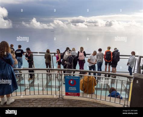 Tourists On A Glass Viewing Platform Above The Steep Sea Cliffs On Cabo