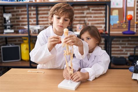 Brother And Sister Students Having Anatomy Lesson At Laboratory