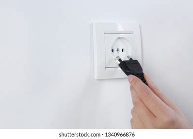 Woman Putting Plug Into Power Socket Stock Photo 1340966876 Shutterstock