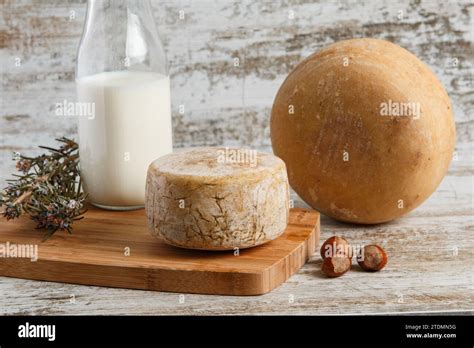 Artisanal And Natural Whole Cheese Placed On A Wooden Board And