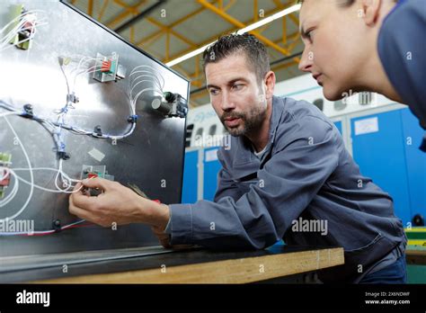 Technicians Fixing Cables Of A Machine Stock Photo Alamy