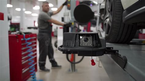 Auto Technician Aligns Car Tire With High Precision At Modern Vehicle