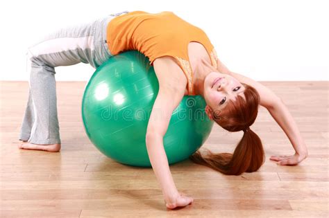 Young Japanese Woman Doing Exercise With Fitness Ball Stock Image