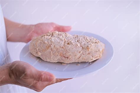 Premium Photo Closeup Of Homemade Whole Grain Bread On A Plate Hands Carrying A Plate With A