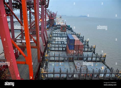 Container Ship Docking At A Large Industrial Port With Cranes Ready For Loading And Unloading