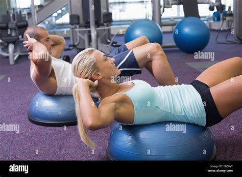 Fit Couple Doing Abdominal Crunches At Gym Stock Photo Alamy