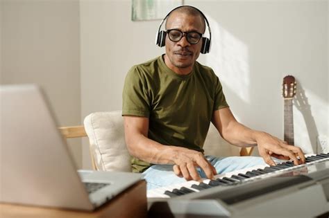 premium photo man learning playing synthesizer