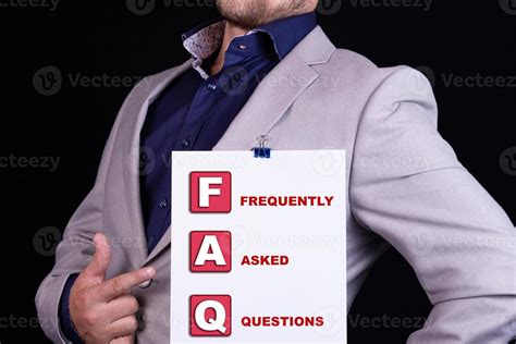A Businessman Holds A Blank Sheet Of Paper With The Text Abbreviated As Faq Frequently Asked