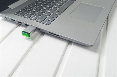 Premium Photo Usb Flash Drive Inserted Into The Laptop Socket On A White Wooden Desk Modern