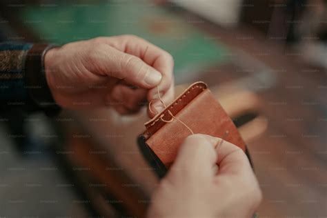 A Person Holding A Wallet With A String Attached To It Photo Art Image On Unsplash