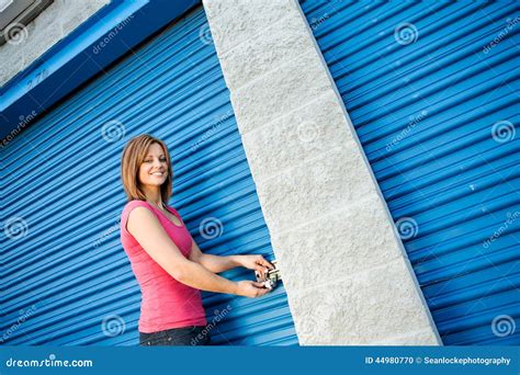 Storage Woman Putting Lock On Unit Door Stock Photo Image Of Combination Open